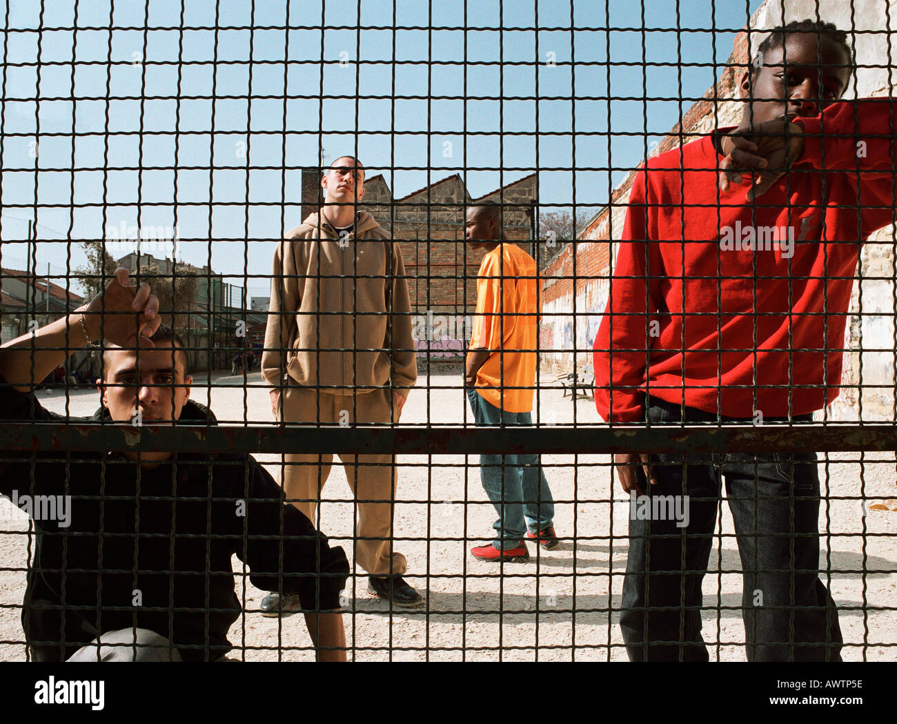 Group of people standing behind fence hi-res stock photography and ...