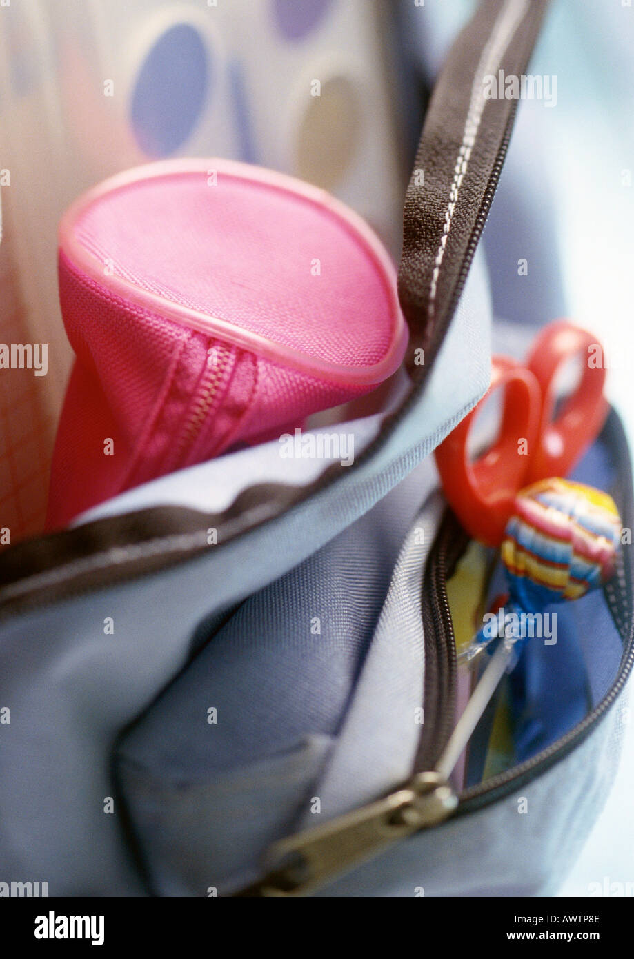 Backpack with scissors, pencil case, lollipop Stock Photo - Alamy