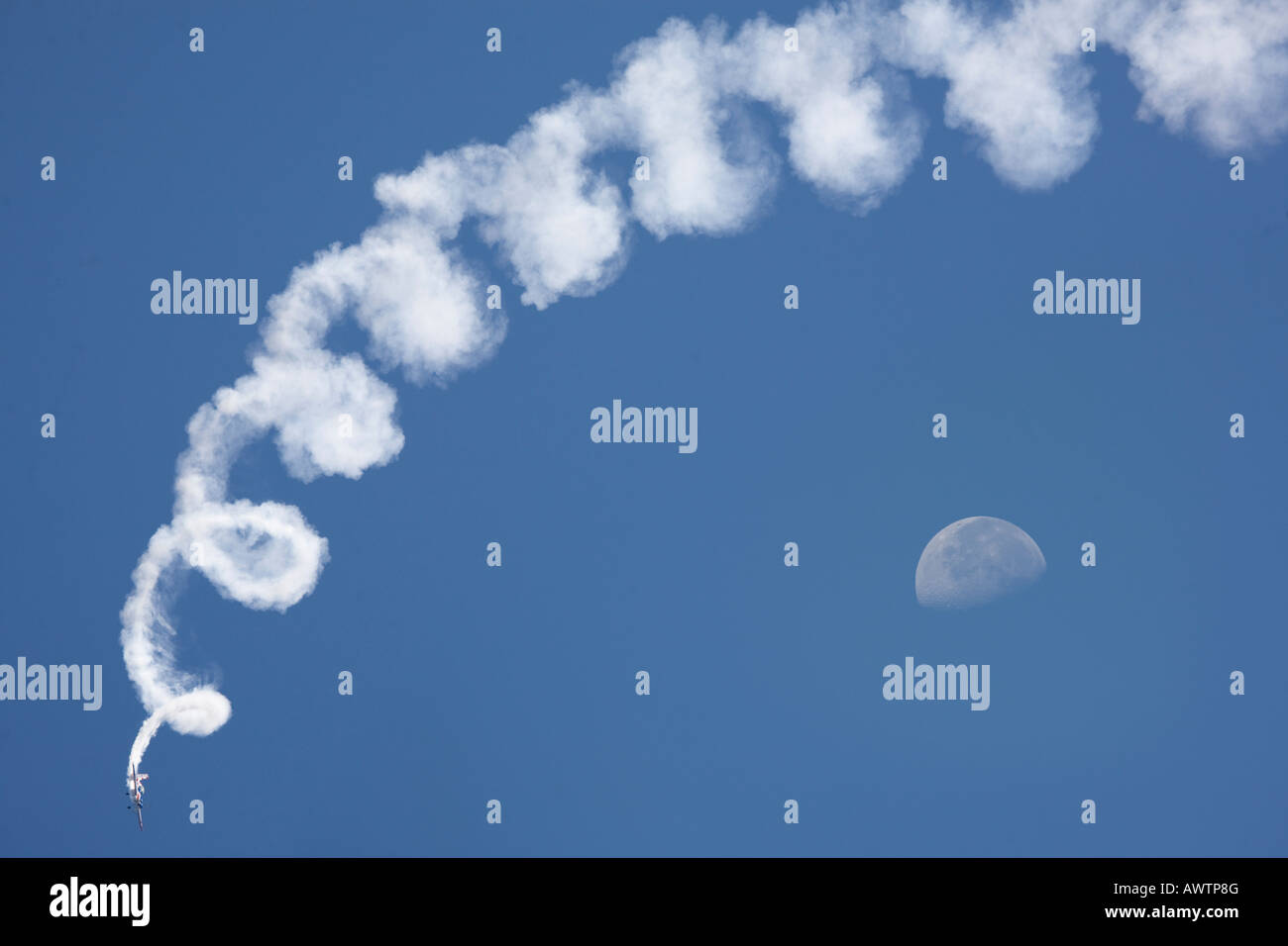 Plane doing loops over the moon Stock Photo - Alamy