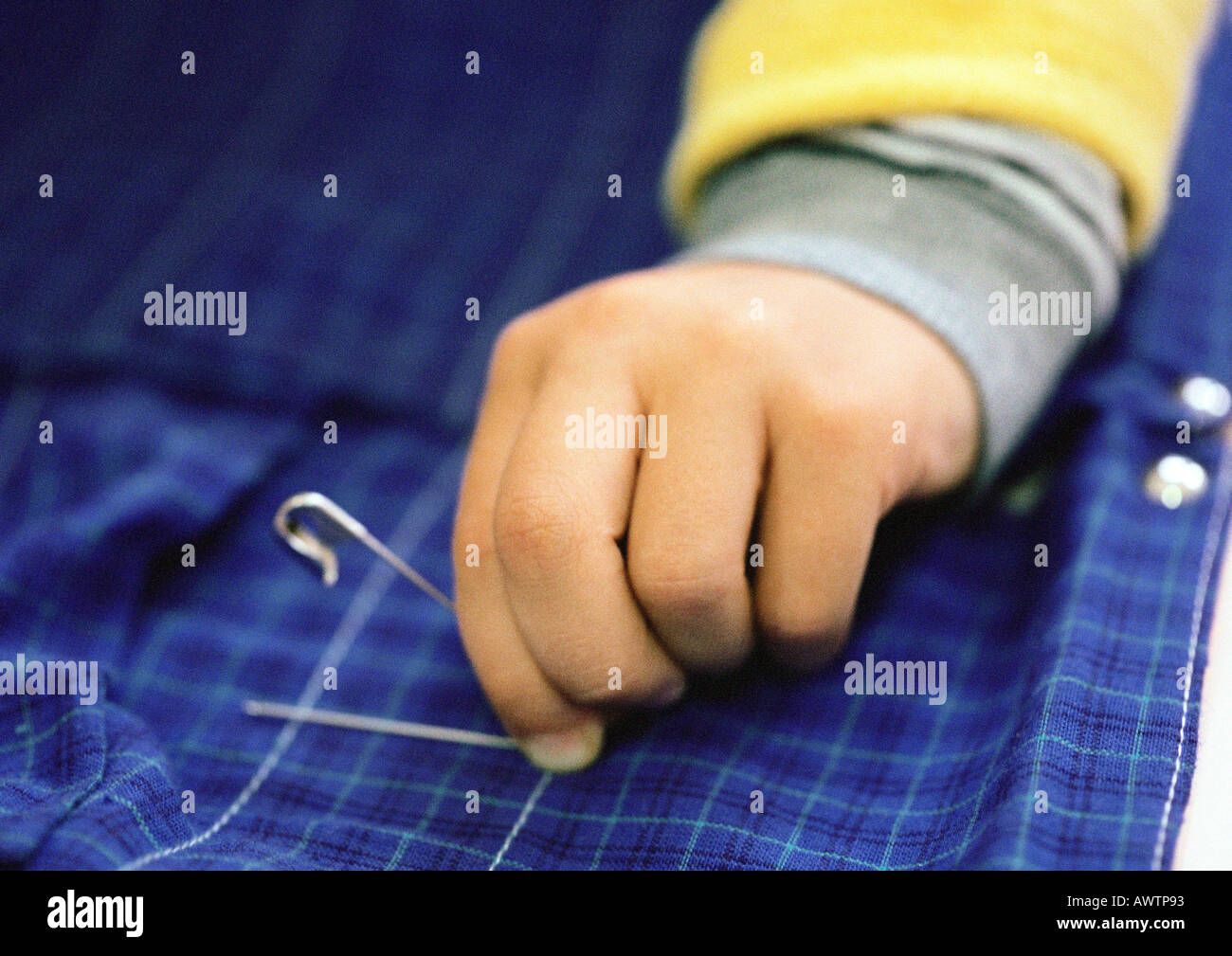 Child's hand holding safety pin, close-up Stock Photo - Alamy