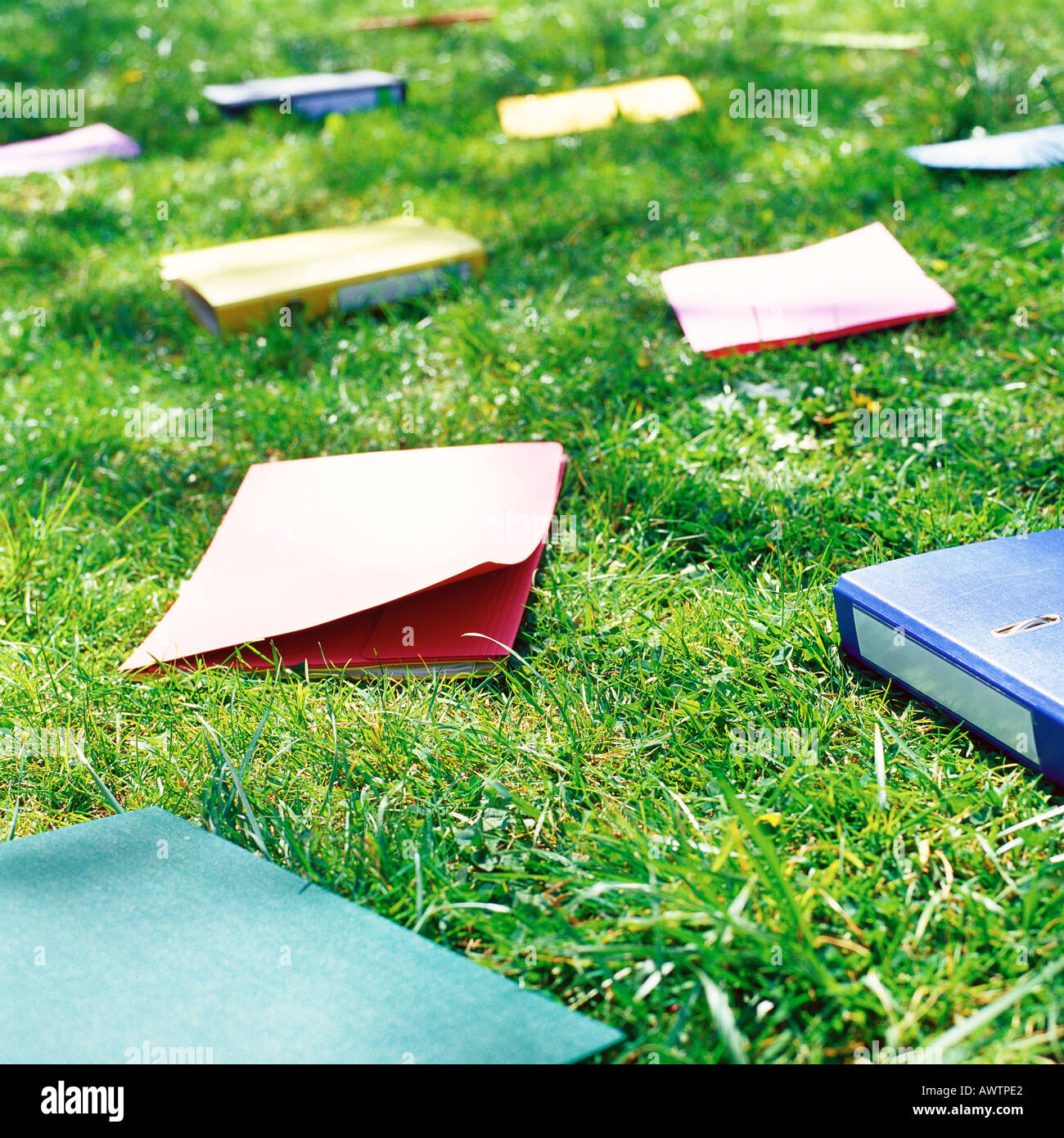 Files, binders scattered on grass Stock Photo - Alamy