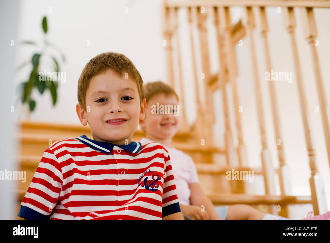 two children standing on wooden stairs Stock Photo - Alamy