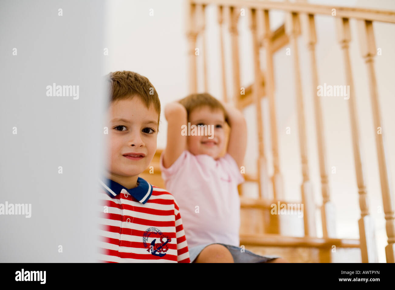 two children standing on wooden stairs Stock Photo - Alamy