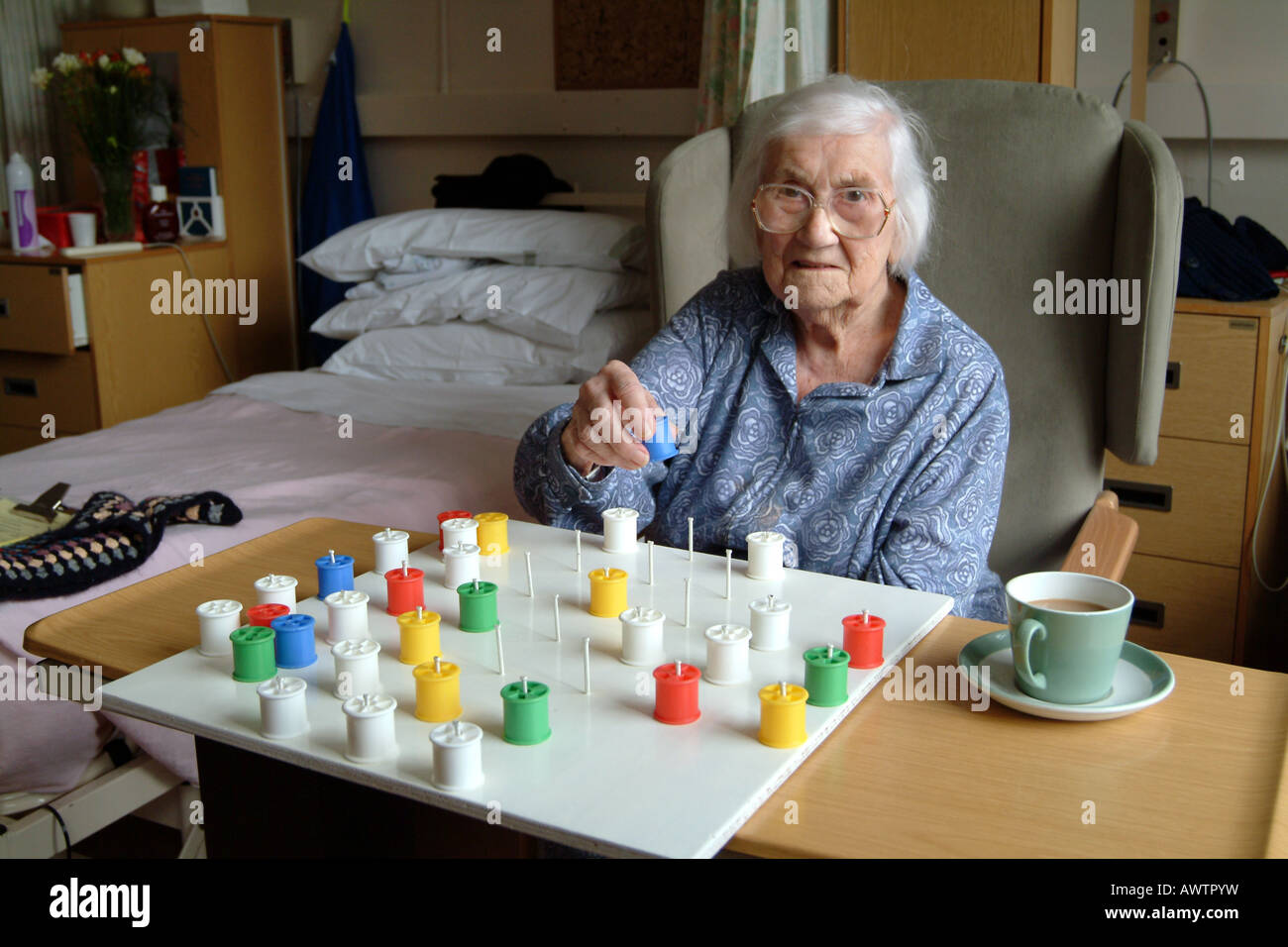 Elderly female patient on hospital ward playing solitaire Stock Photo ...