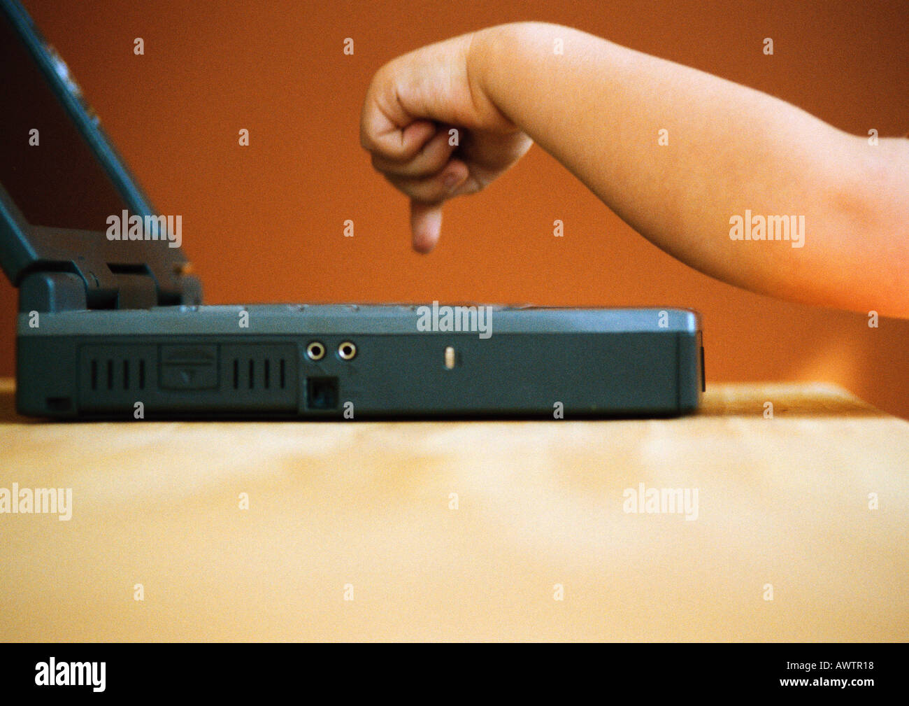 Child's hand poised over laptop computer, cropped view Stock Photo - Alamy