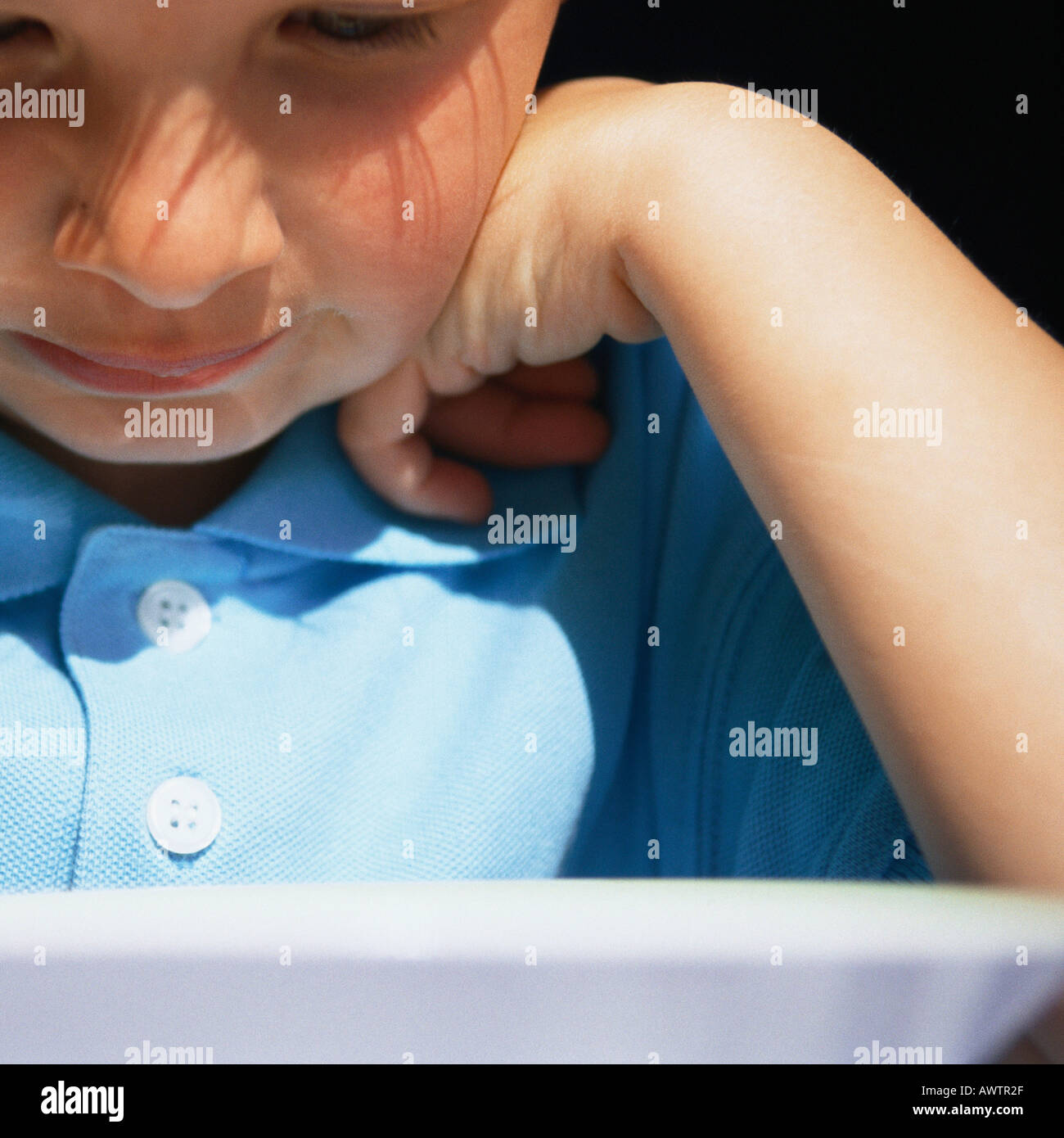Child holding head, looking down, close-up Stock Photo - Alamy
