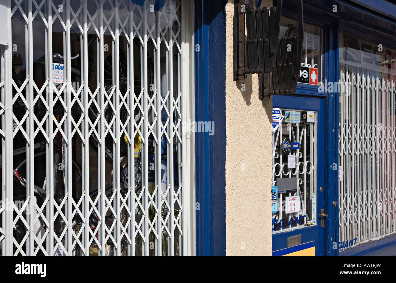 Security grille over shop window UK Stock Photo - Alamy
