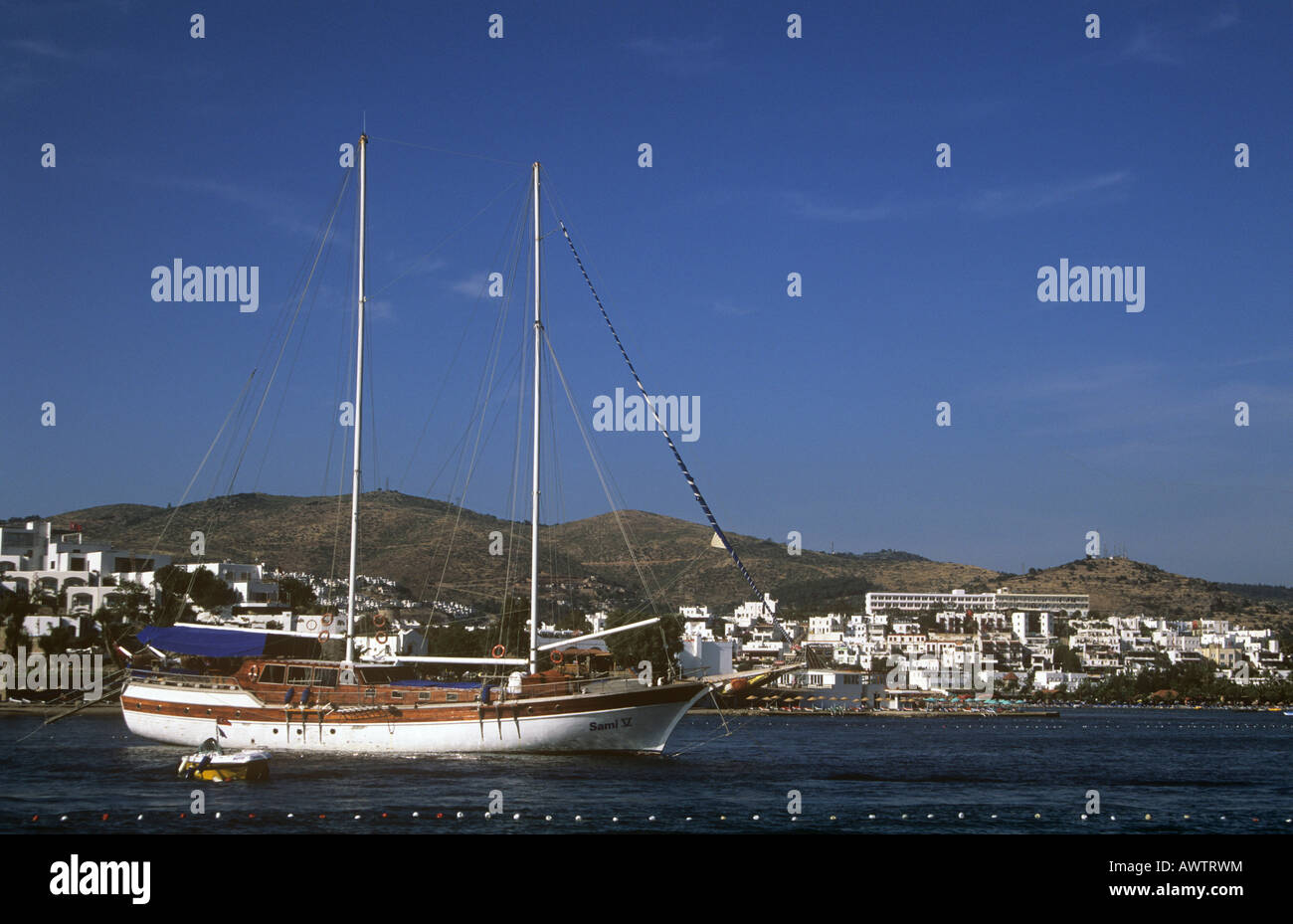 Traditional two masted wooden sailing vessel called a gulet is anchored ...