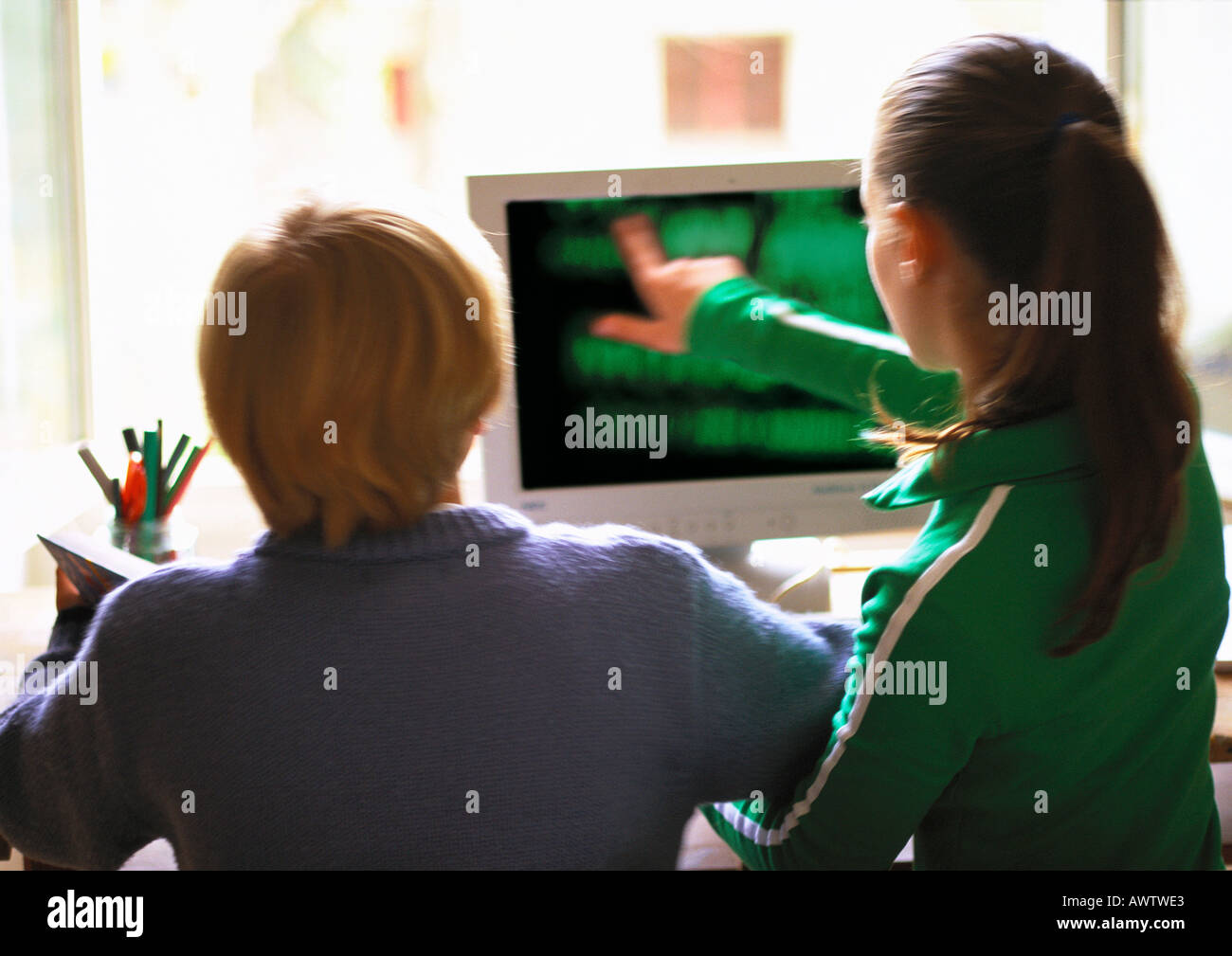 Young boy and girl using computer together, rear view Stock Photo - Alamy