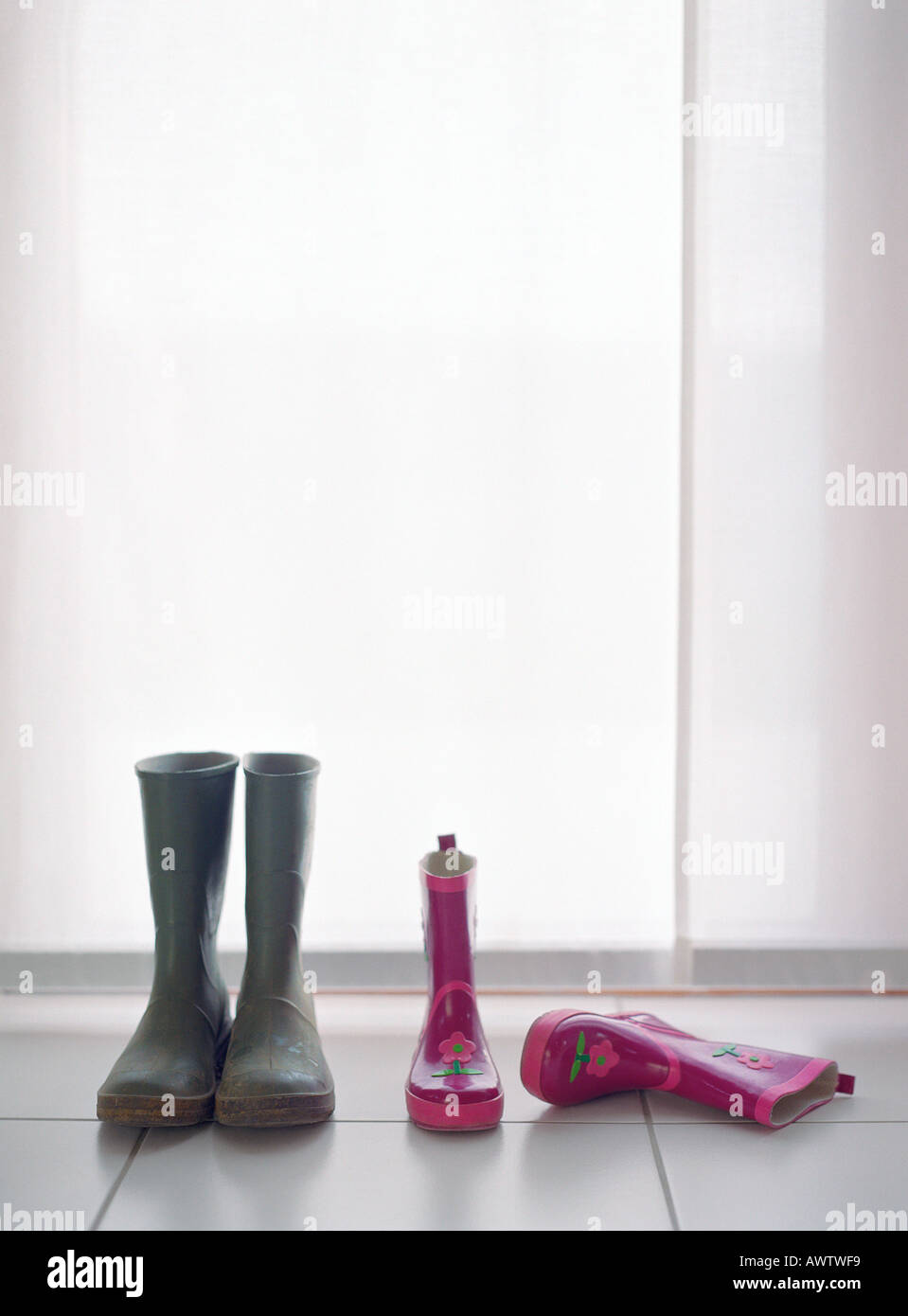 Two pairs of rubber boots, one boot resting on side Stock Photo - Alamy