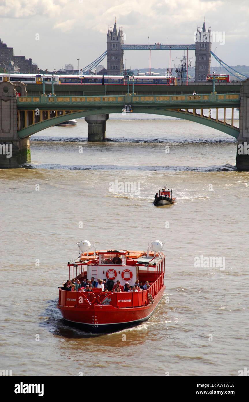 Passenger cruiser on the River Thames looking east to Tower Bridge ...