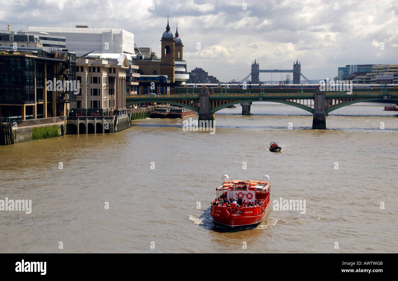 Passenger cruiser on the River Thames looking east to Tower Bridge ...