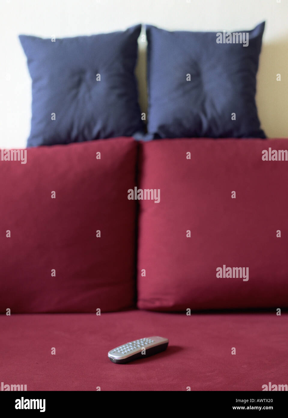 Remote control on couch Stock Photo - Alamy