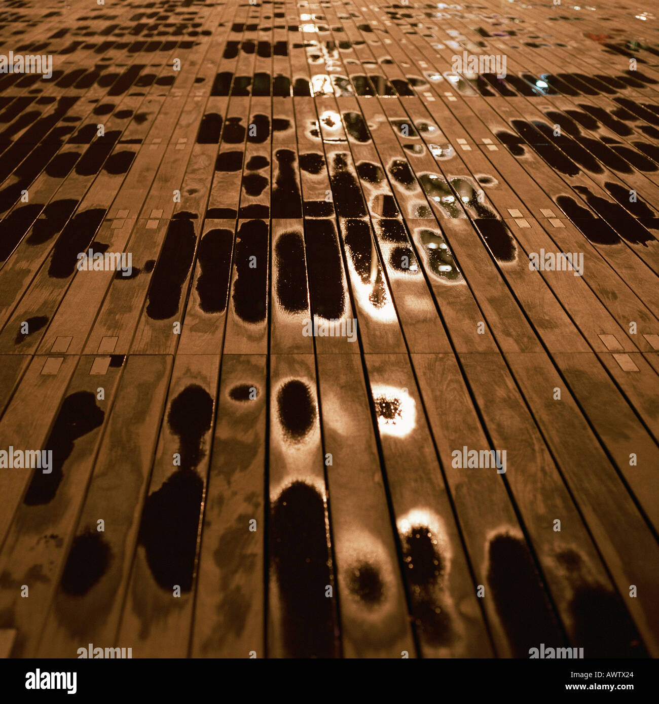 Puddles of rain on boardwalk at night Stock Photo - Alamy