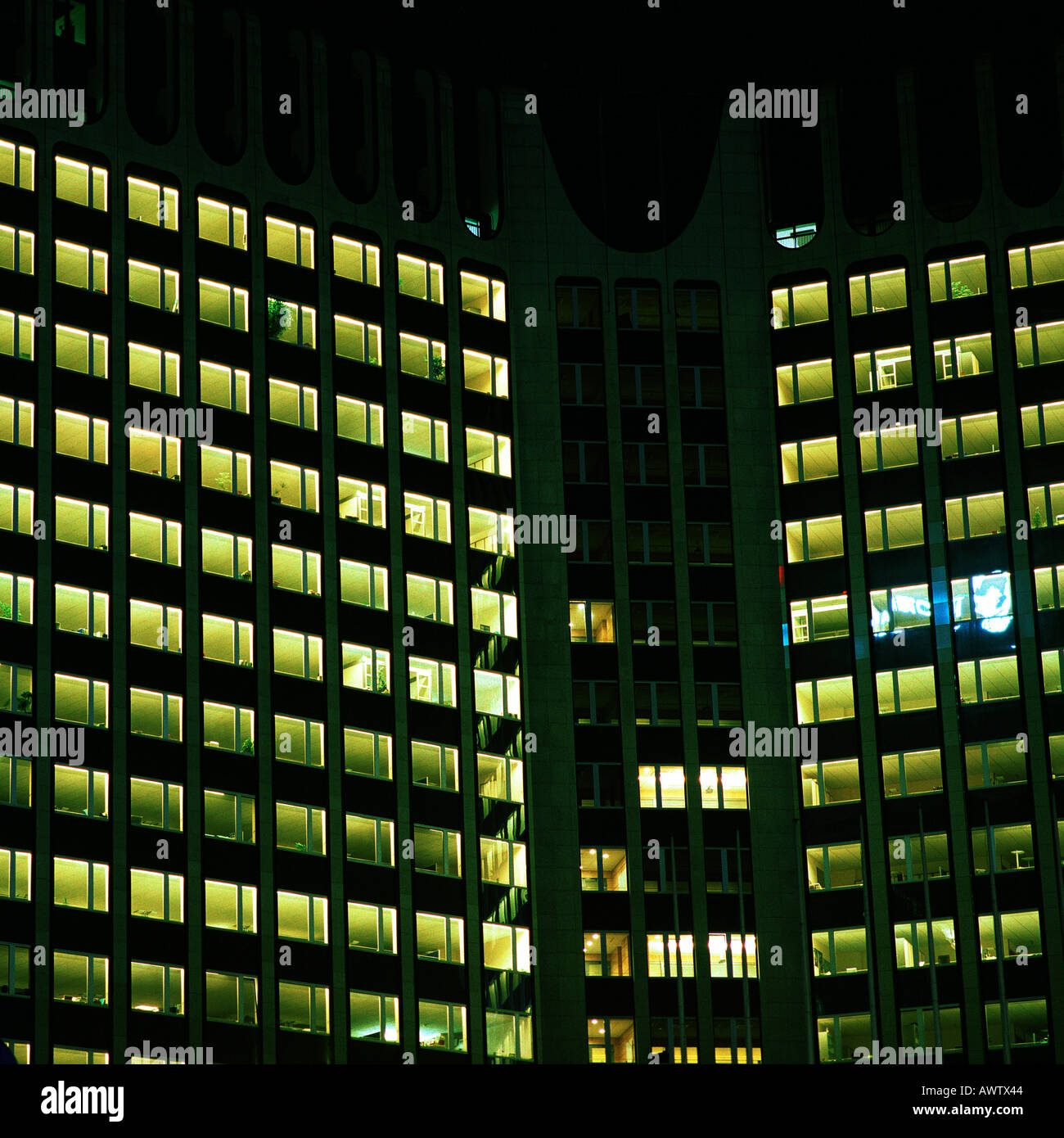 Office buildings lit up at night, exterior Stock Photo - Alamy