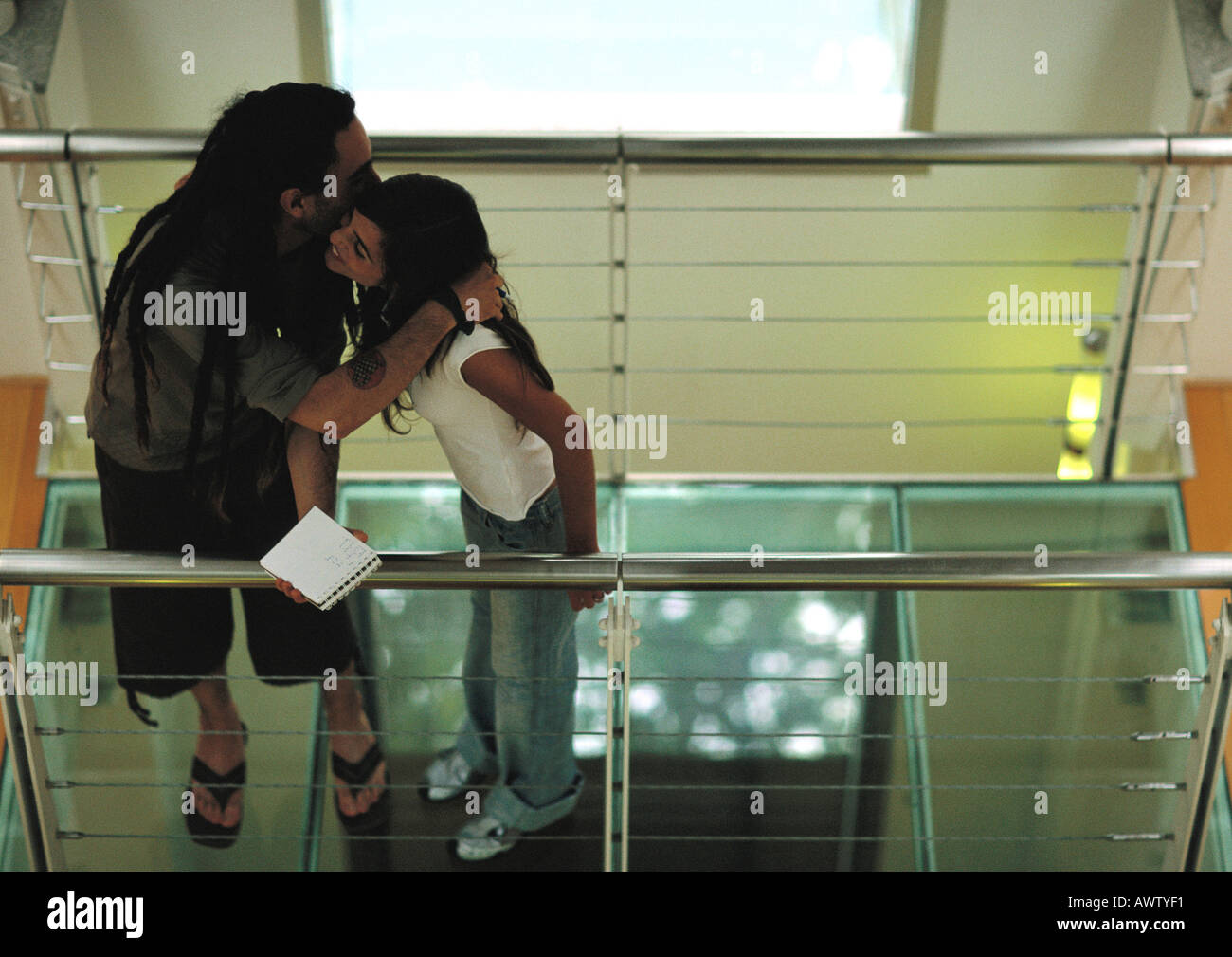 Man holding paper in hand, hugging woman, view from above Stock Photo ...