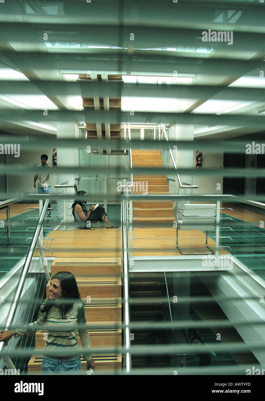 Woman walking down stairs, view through window blinds Stock Photo - Alamy