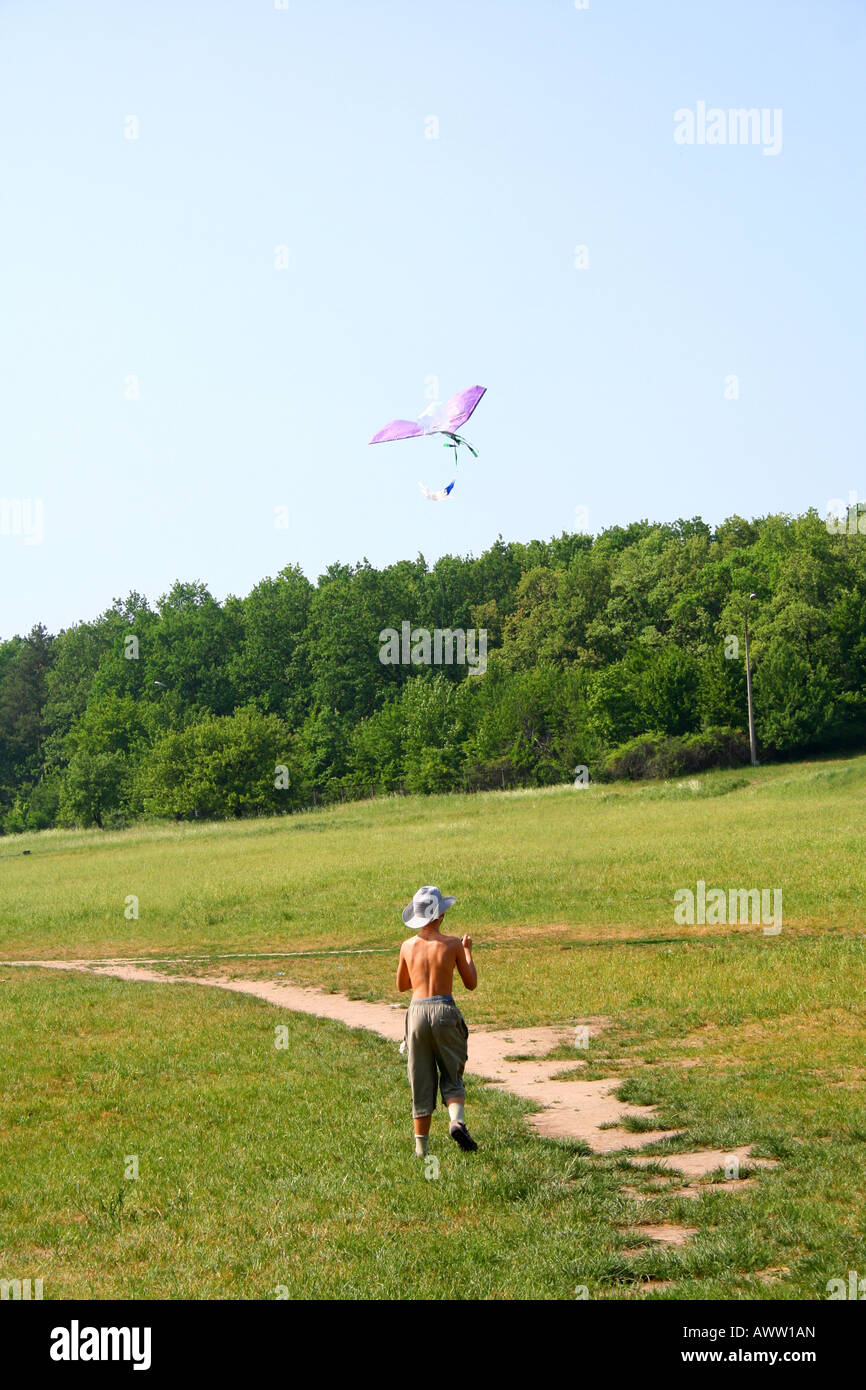 Kid with the flying kite Stock Photo - Alamy