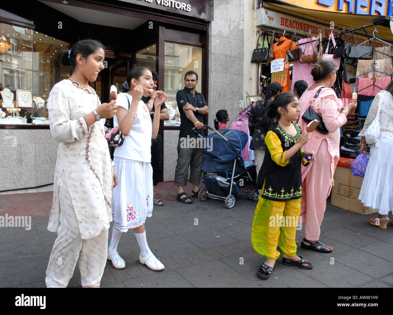 Street scene of people eating ice creams in Southall Middlesex Stock ...