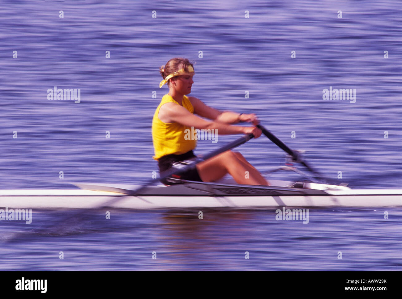 A young woman works out in a single shell on a sunny day Stock Photo ...