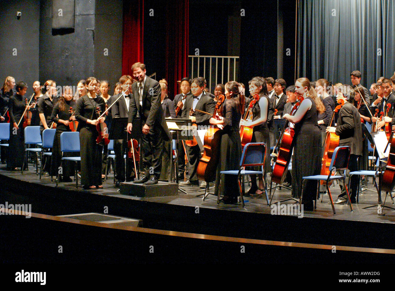 Conductor Michael Hall bows at end of performance by Pacific Symphony ...