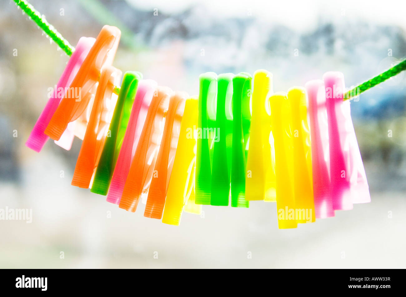 Clothes pegs on string against bright sunlight Stock Photo - Alamy