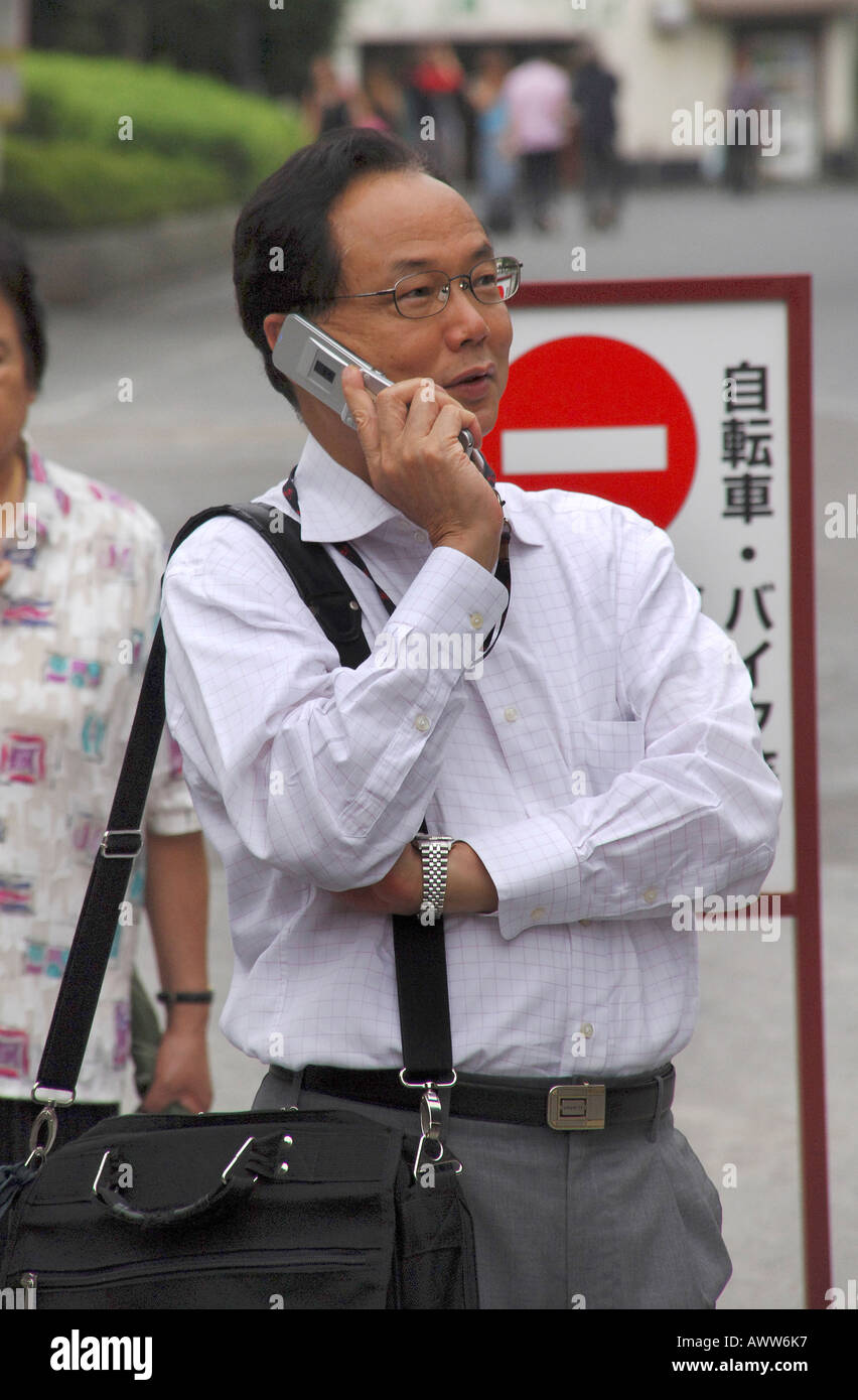 Japanese man using cellphone Stock Photo - Alamy