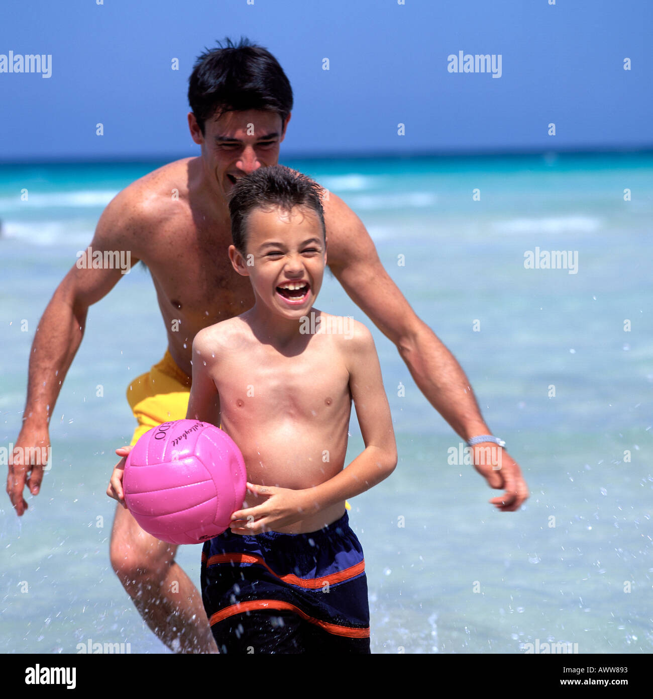 FATHER CHASING SON IN SEA Stock Photo - Alamy