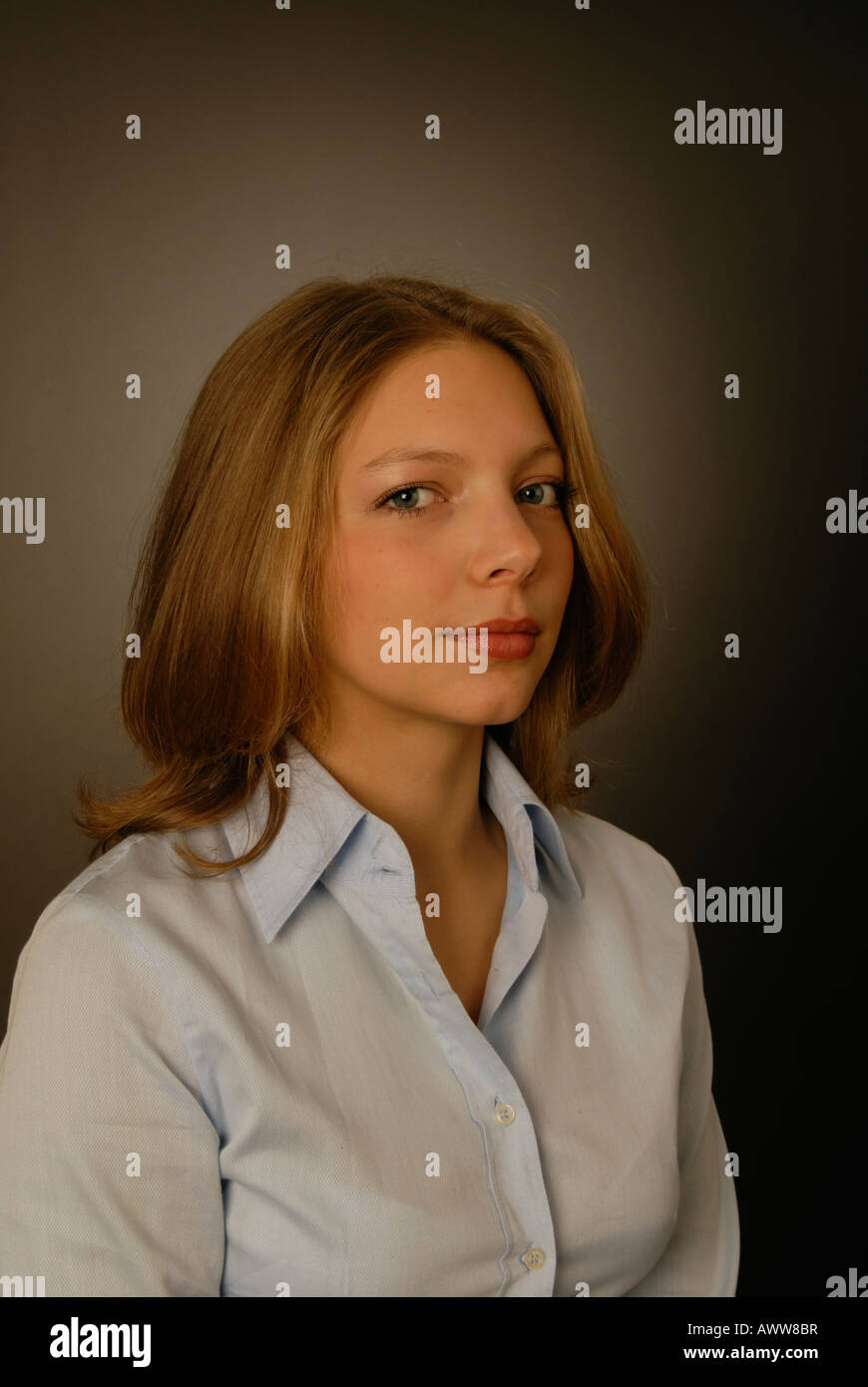 Whimsically, cheekily looking young lady. Young woman, teenager, girl ...