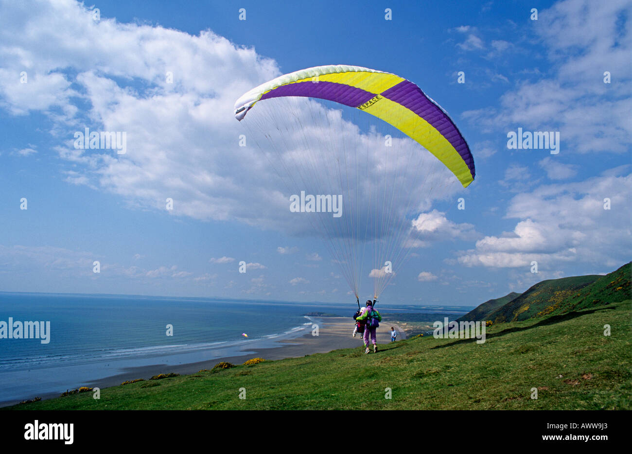 Pair of tandem hang gliders at point of take off above Rhossili Bay on ...