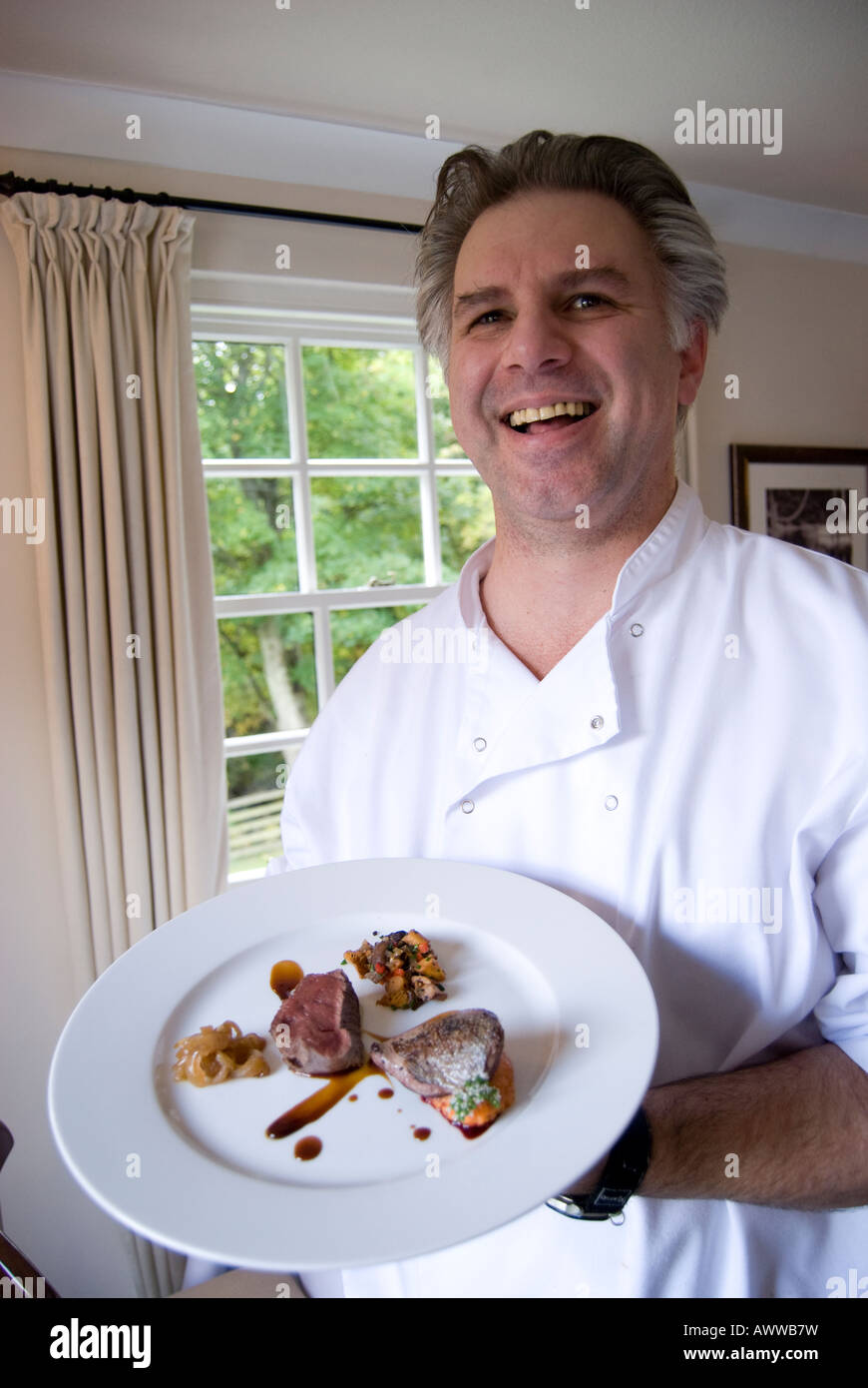 A chef and Inn owner in Scotland serving a wild game dish Stock Photo ...