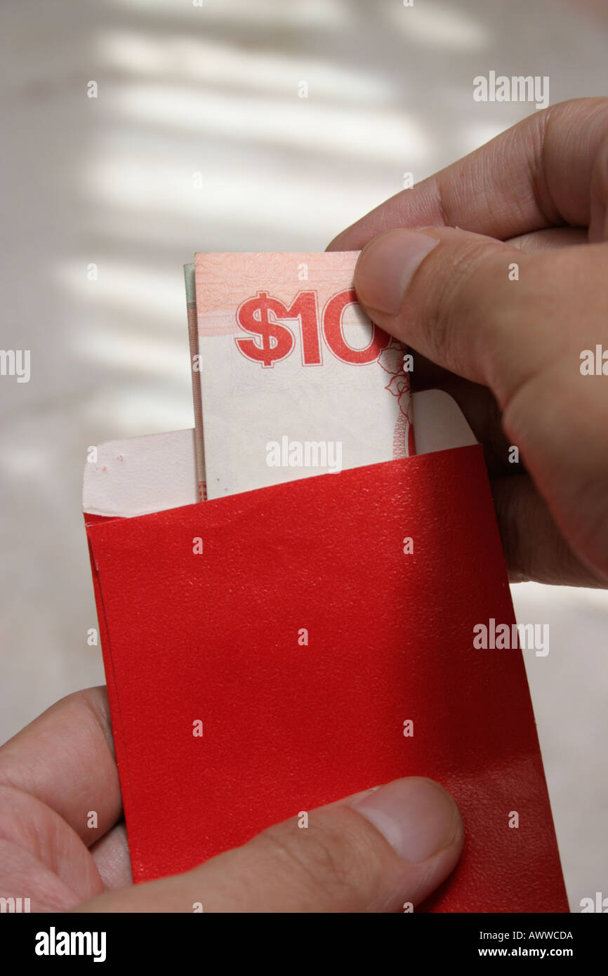 hand taking out singaporean $10 note from a red packet during chinese ...