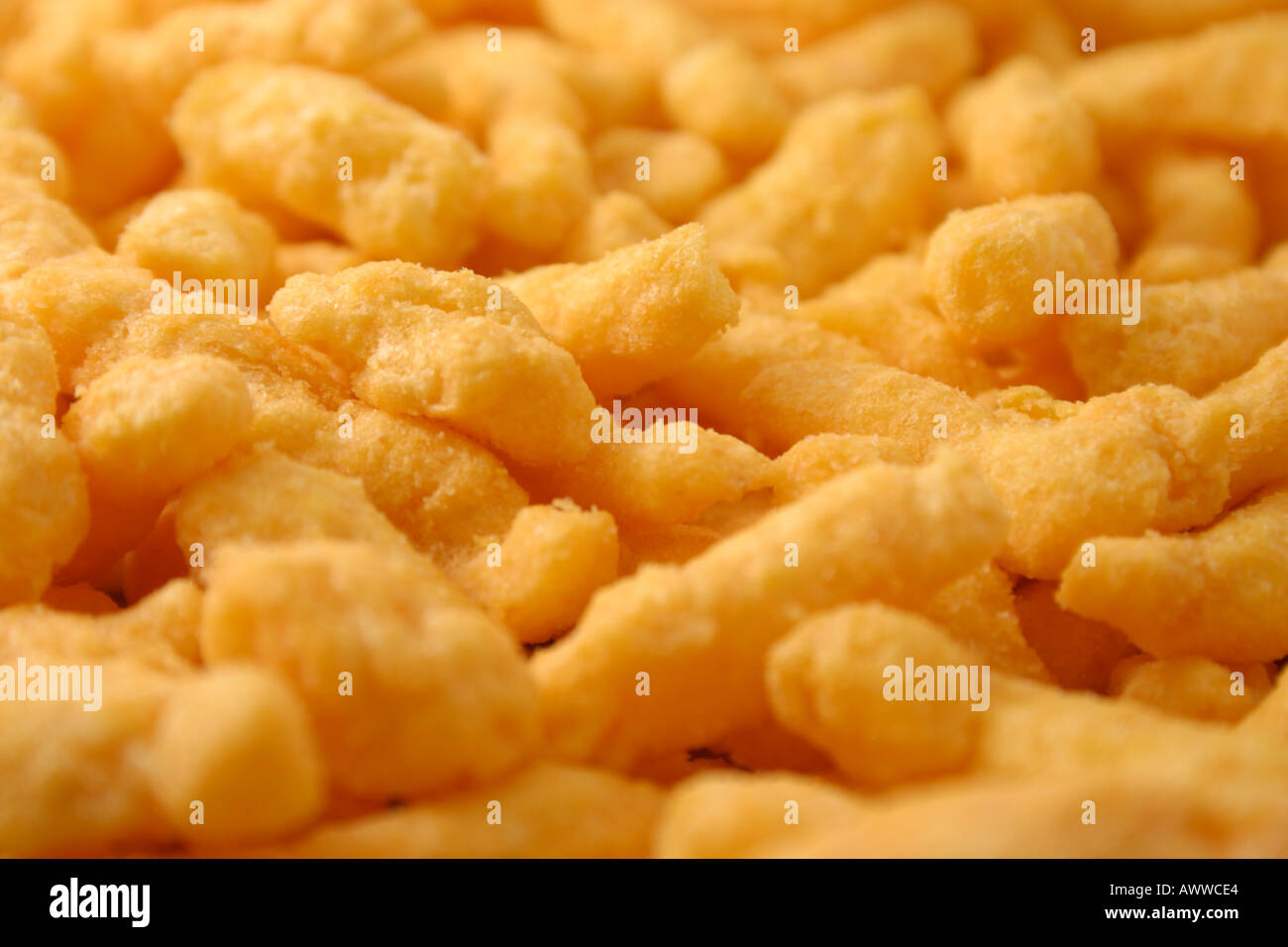 angled closeup of yellow curled crispy corn snacks horizontal Stock ...