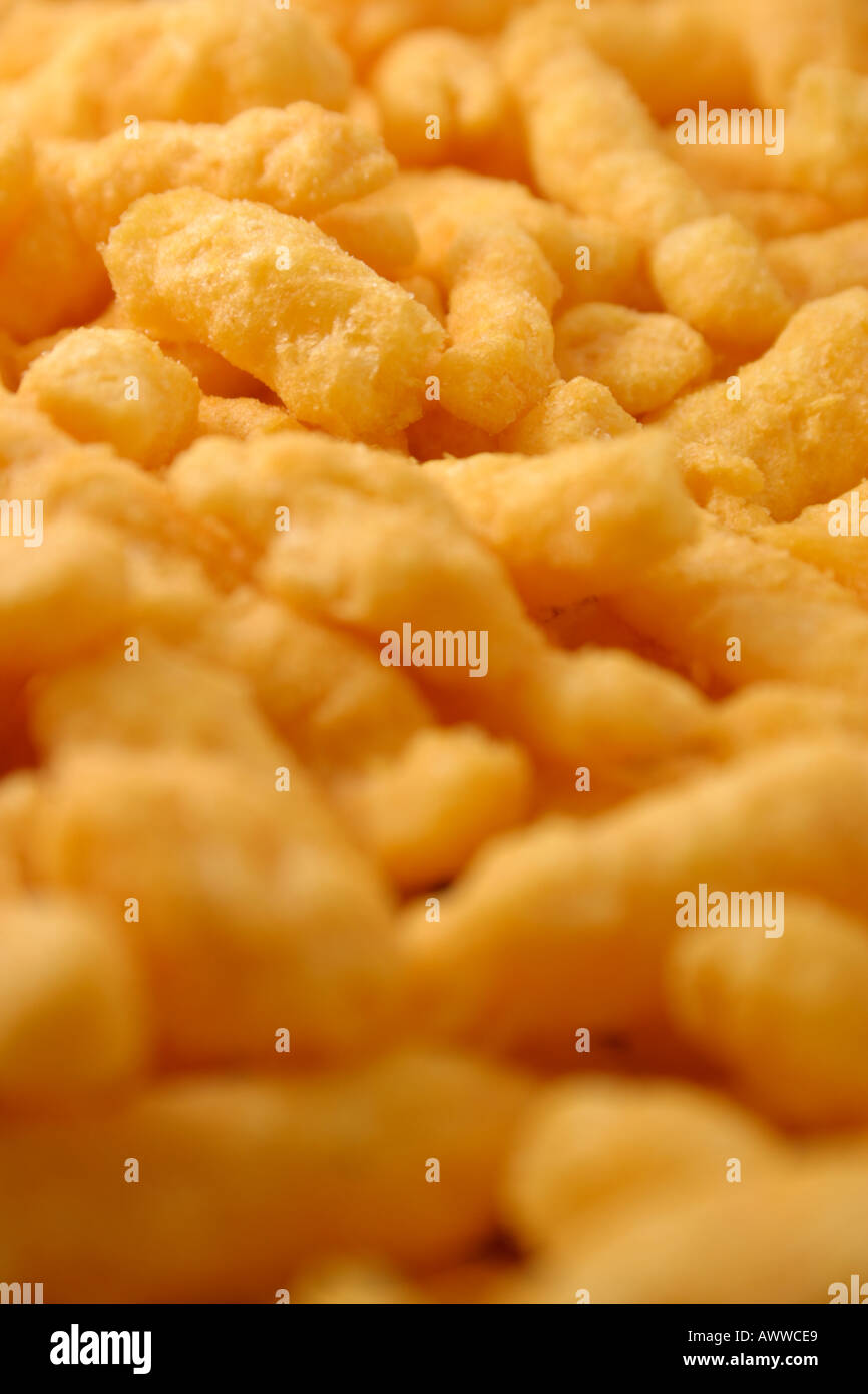 angled closeup of yellow curled crispy corn snacks vertical Stock Photo ...
