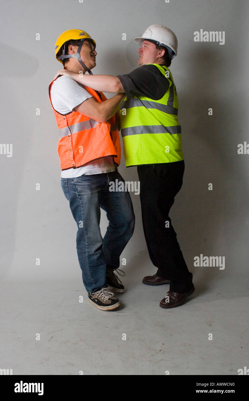Two workmen in day-glow jackets fighting Stock Photo - Alamy