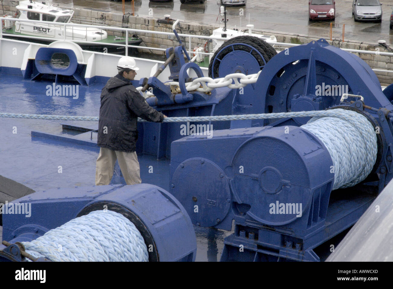 Seaman preparing hawser for mooring on a ship about to dock Stock Photo ...