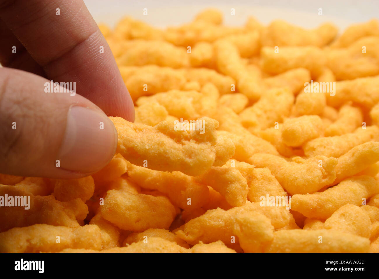 hand picking up crispy corn snack Stock Photo - Alamy