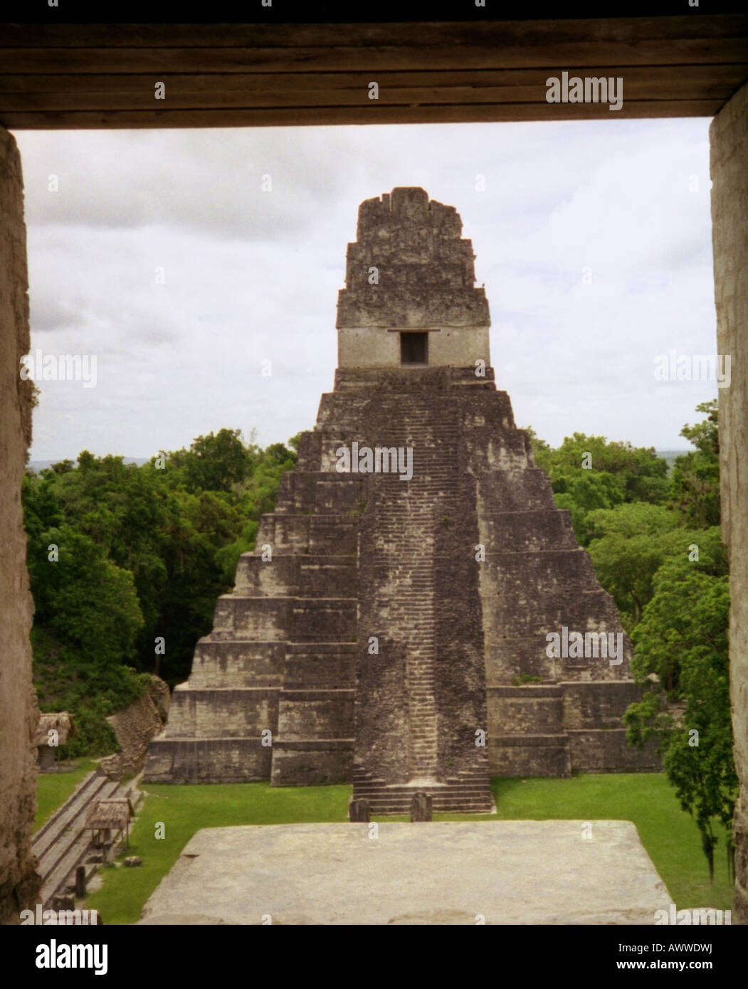 Panoramic view imposing Maya stone pyramid through entry door at top ...