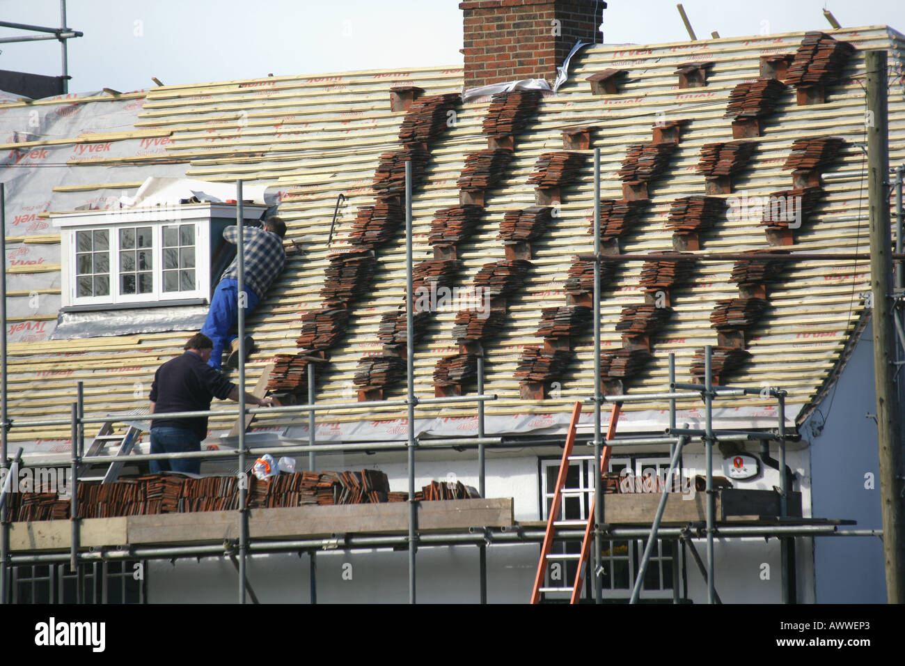 Roofers at work, Essex, England, UK Stock Photo - Alamy