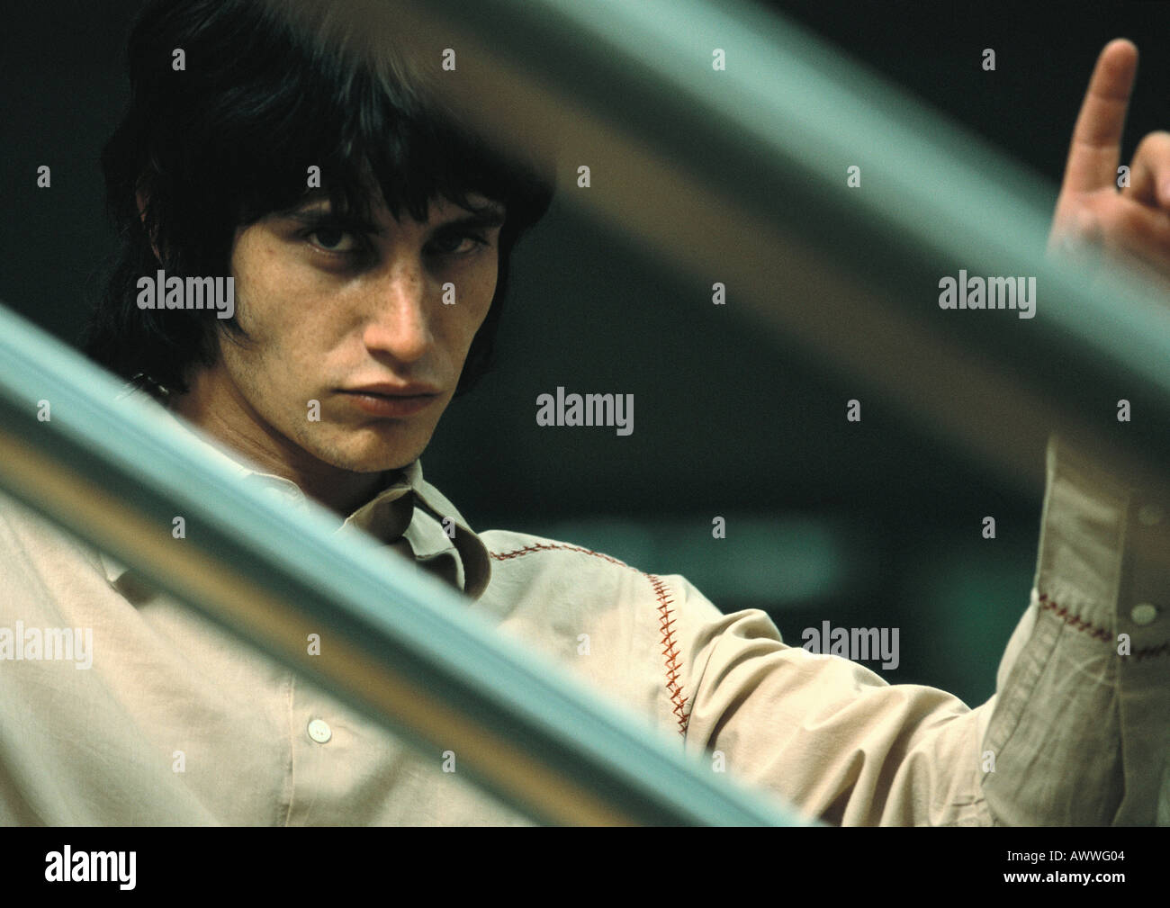 Man pointing up, metal railing in foreground Stock Photo - Alamy