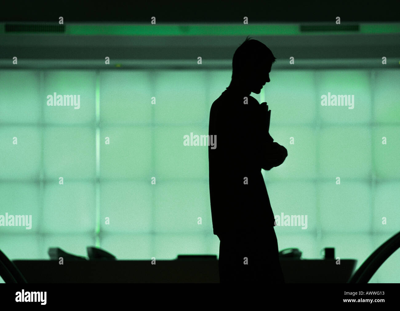 Man standing in front of windows, silhouette Stock Photo - Alamy