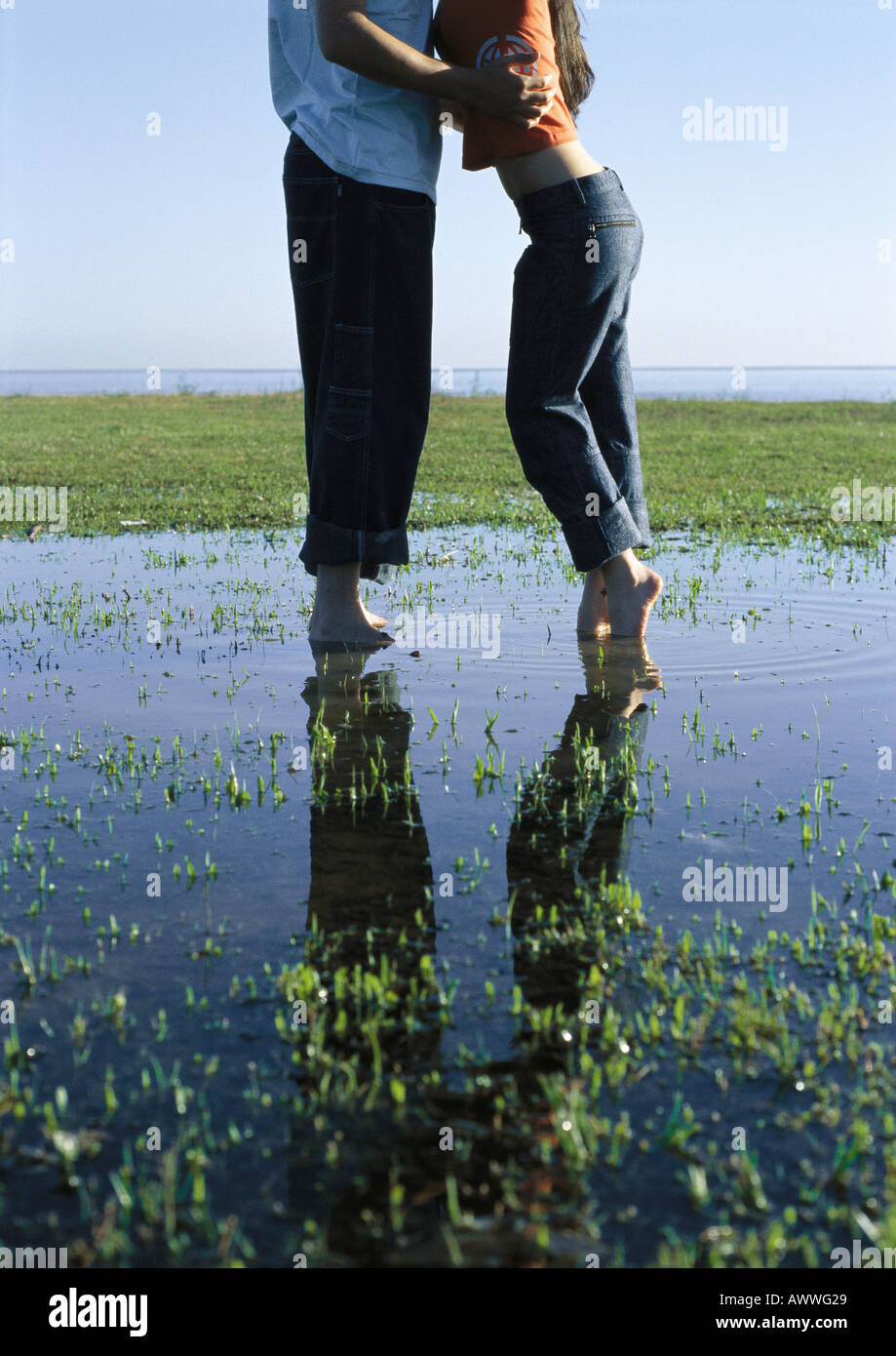 Young couple standing in puddle passionately embracing Stock Photo - Alamy