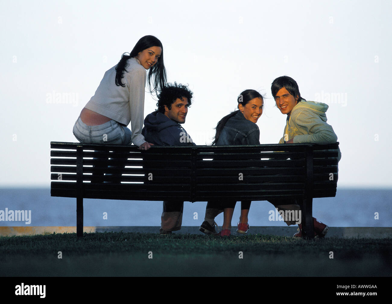 Four girls sitting on the bench hi-res stock photography and images - Alamy