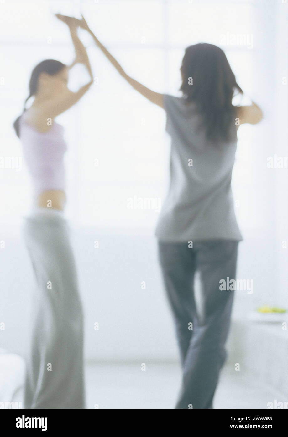 Two young women dancing, blurred Stock Photo - Alamy