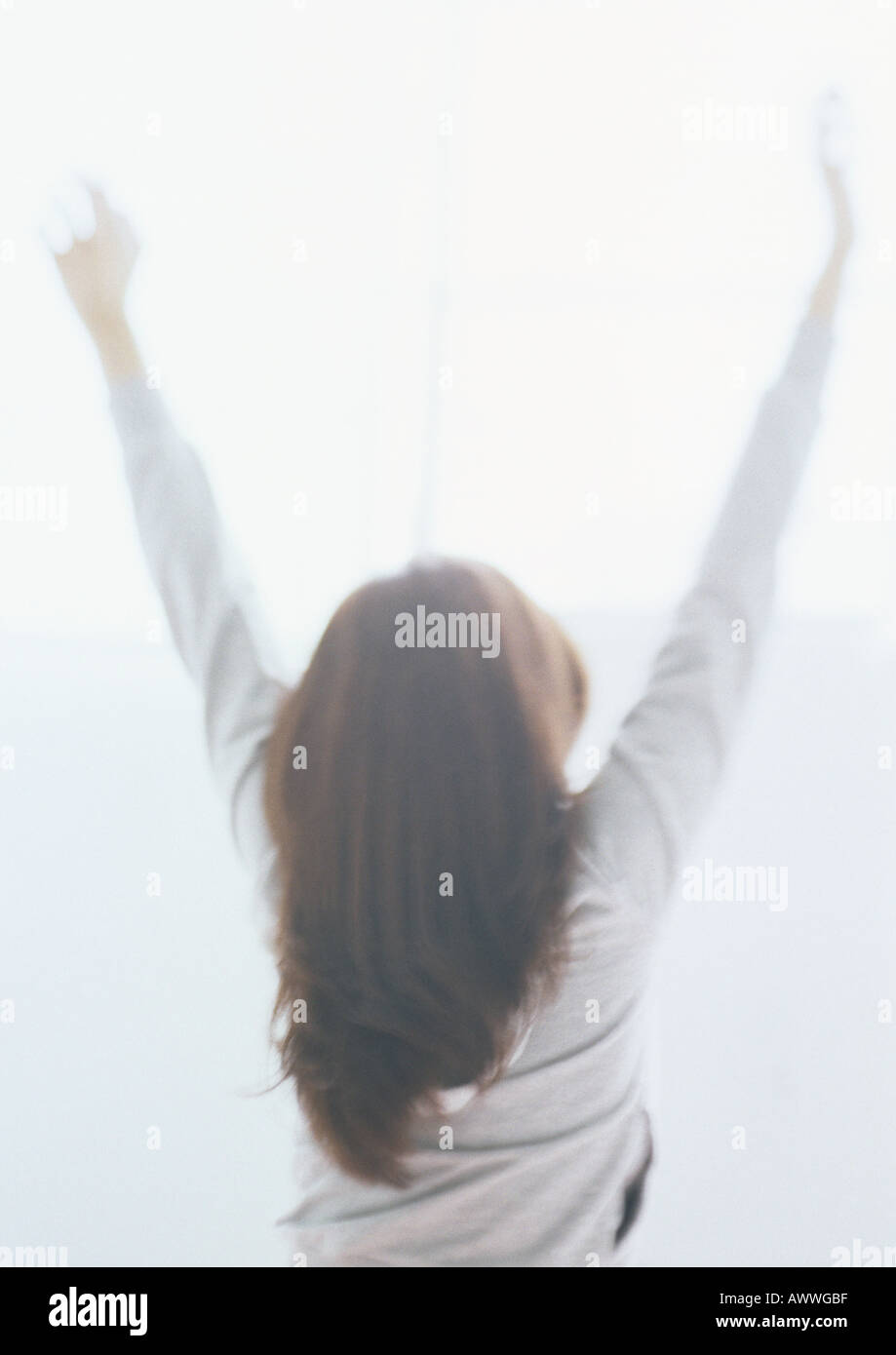 Woman with raised arms, rear view Stock Photo - Alamy