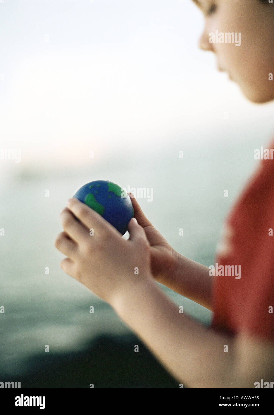 Child holding ball, close-up, blurred Stock Photo - Alamy