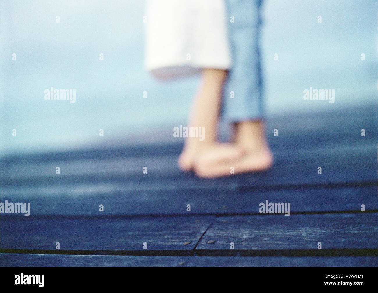 Child standing on other child's feet, low section, blurred Stock Photo ...