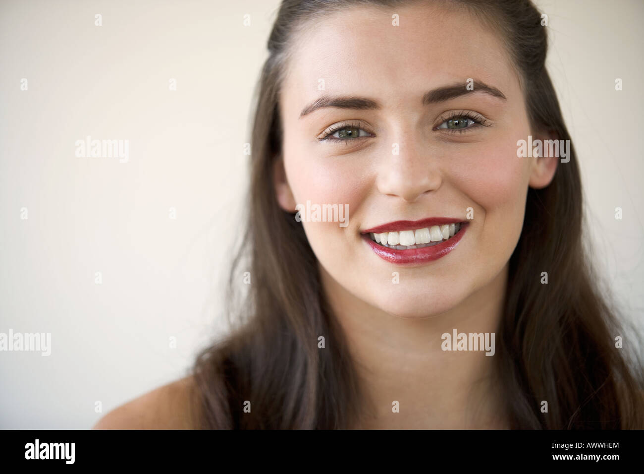 Portrait of young woman with long brown hair, smiling Stock Photo - Alamy