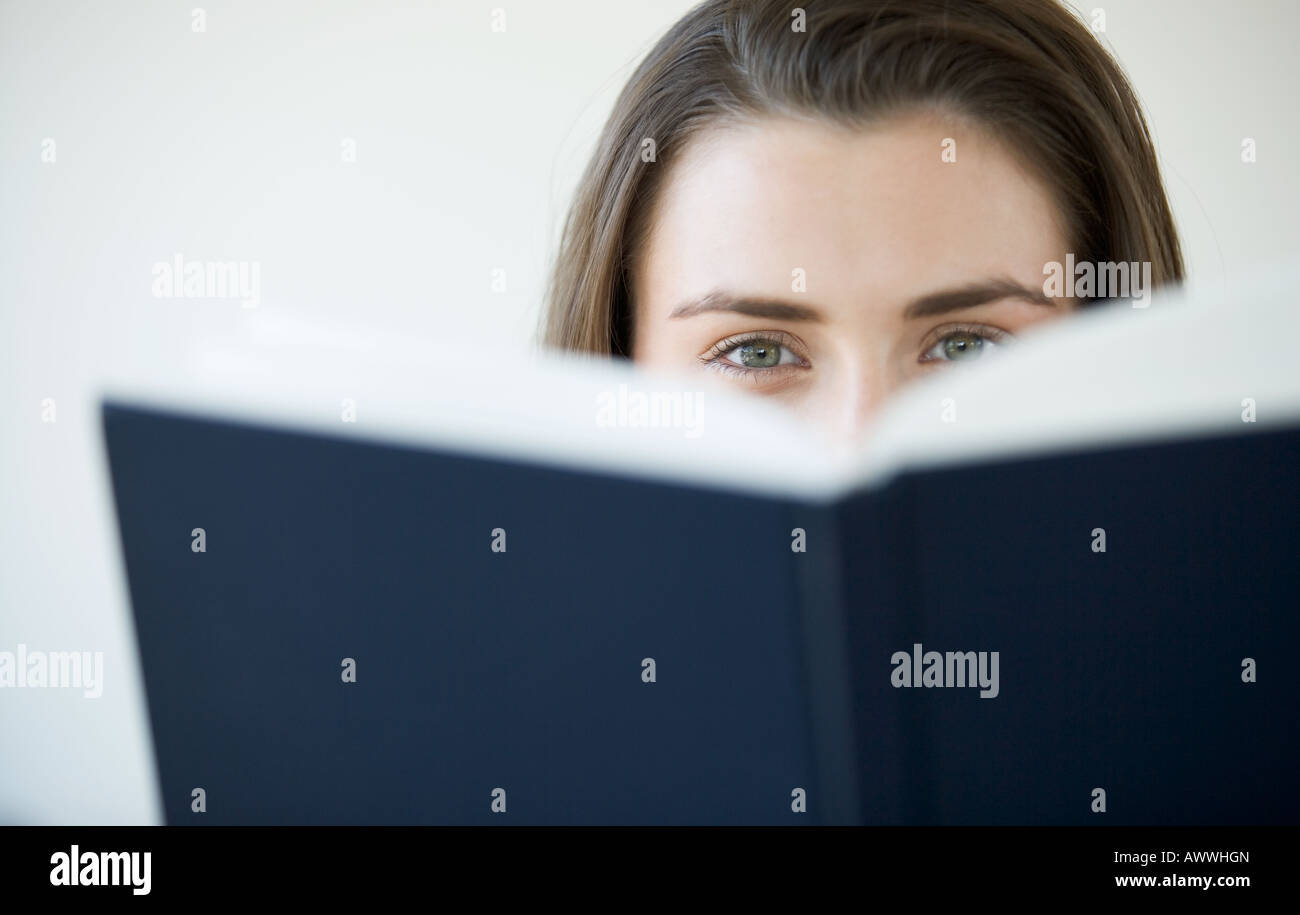 Hands hiding open book hi-res stock photography and images - Alamy