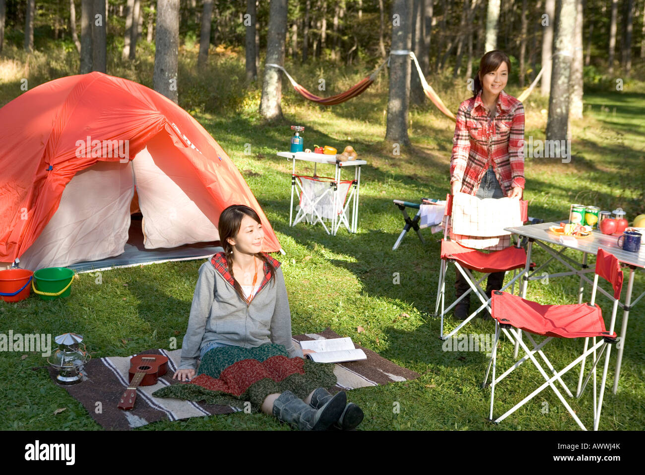 Teenage girls camping, rural scene Stock Photo - Alamy